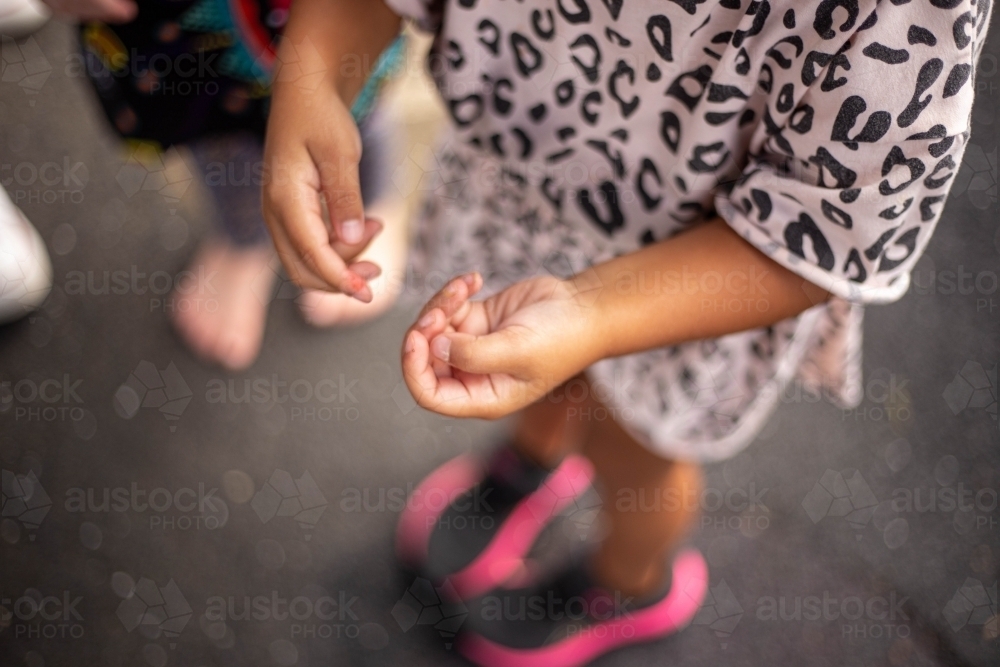 Image of Out of focus hands of a young Aboriginal girl at preschool ...