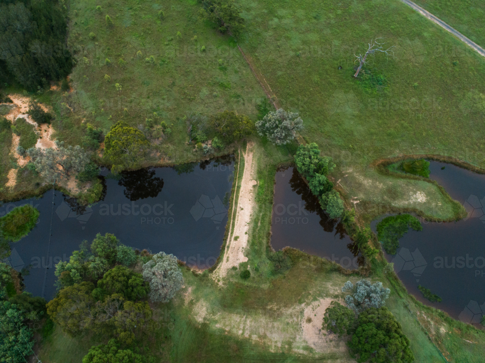 Image of overhead aerial perspective of dams in paddocks on overcast ...
