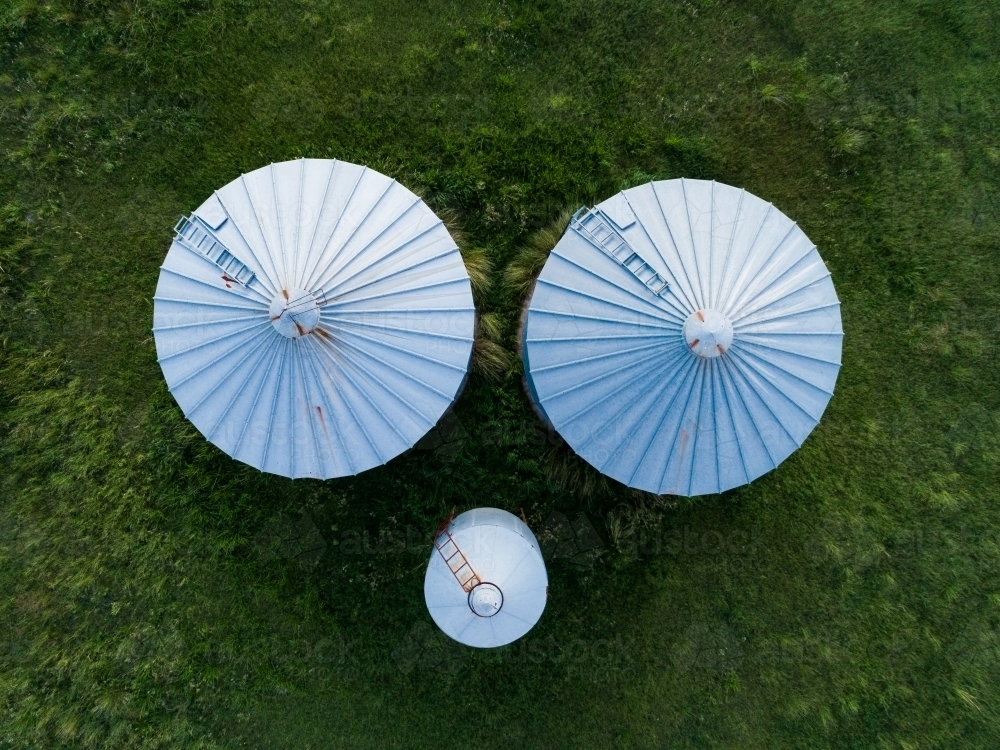 Image of Overhead aerial view of three grain storage silos on a farm ...