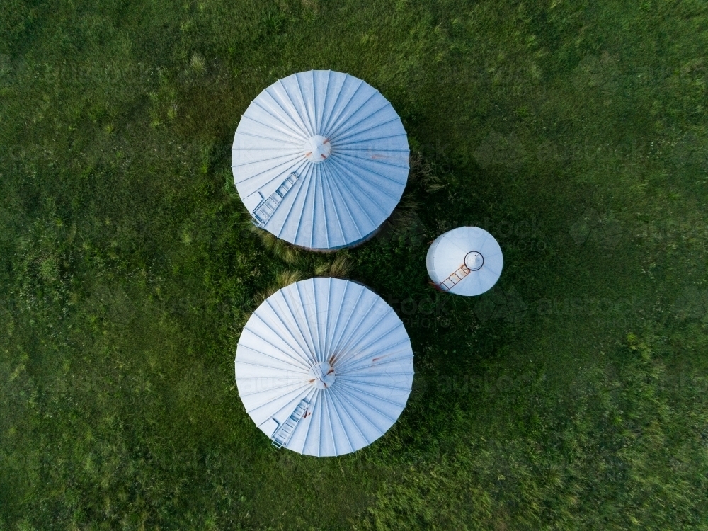 Image of Overhead aerial view of three grain storage silos on a farm ...