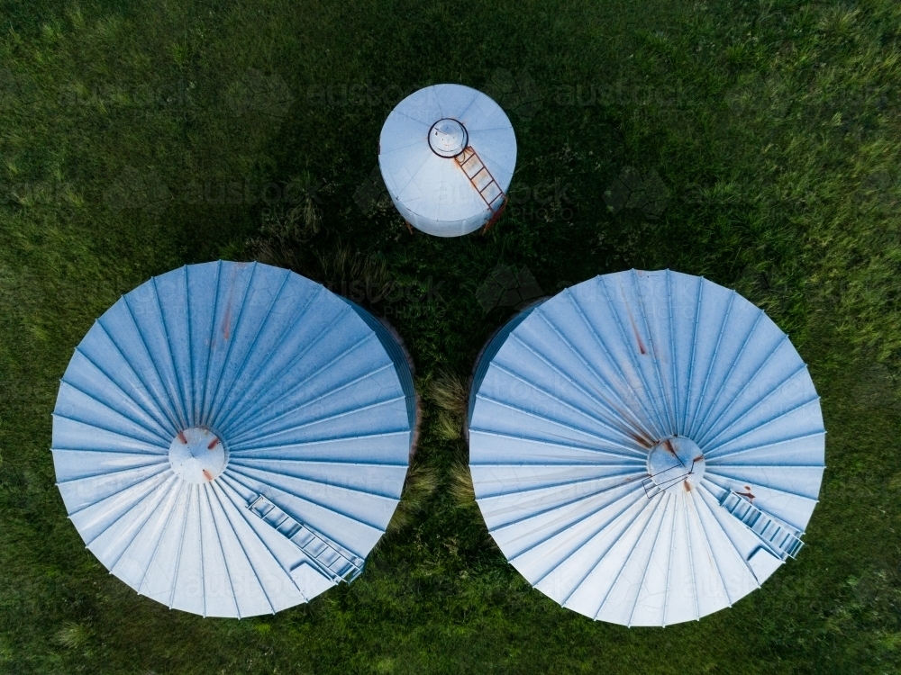 Image of Overhead aerial view of three grain storage silos on a farm ...