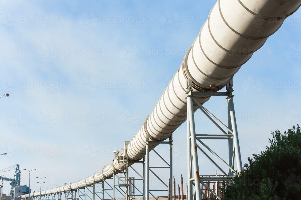 Image of Overhead pipeline running to a port - Austockphoto