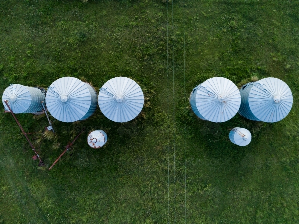 Image of Overhead top down aerial view of grain silos in green farm ...