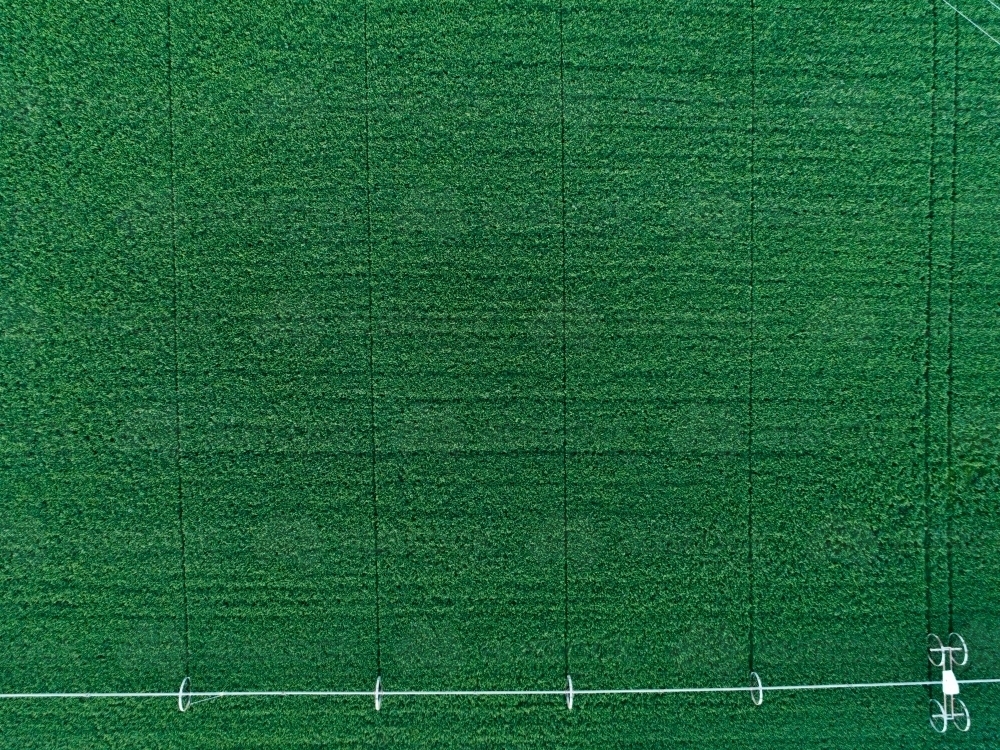 Image of Overhead view of green paddock with farm irrigation system at ...