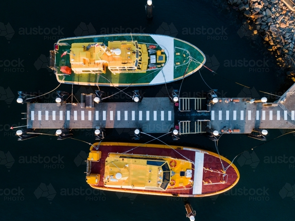 Image of Overhead view of red and green port authority boats at Jetty ...