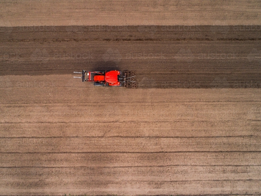Image of Overhead view of tractor on farm ploughing soil ready for ...