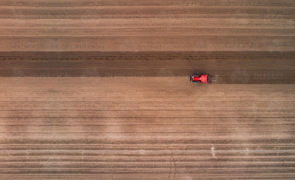 Image of Overhead view of tractor on farm ploughing soil ready for ...