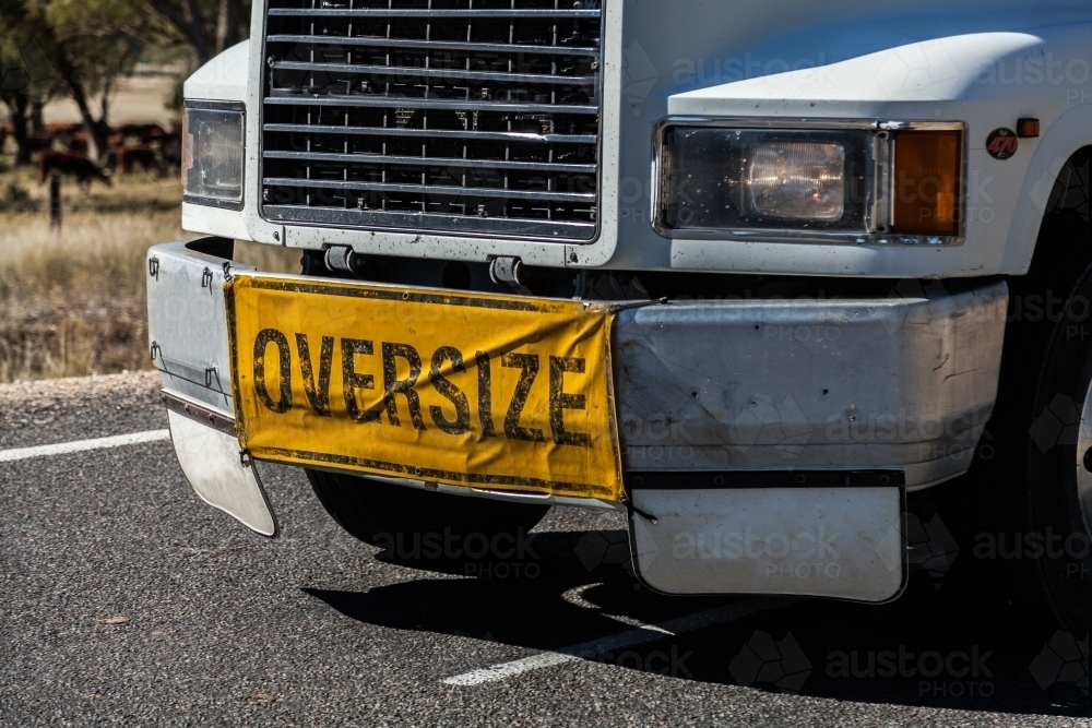 Image of Oversize banner on oversized truck - Austockphoto