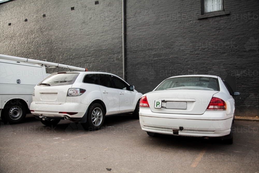 Image of P2 plate car parked over line in car park - Austockphoto