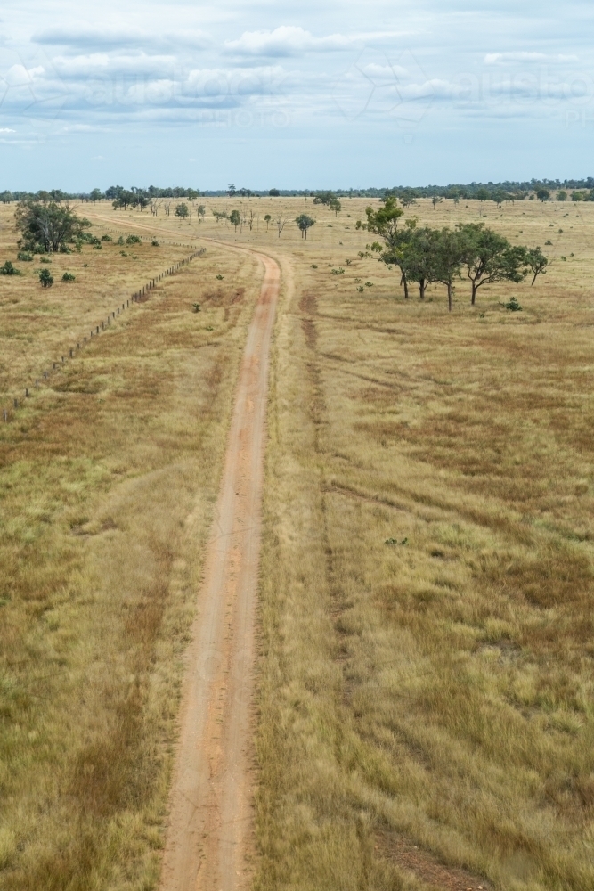 Image of Paddock and dirt road on farm. - Austockphoto