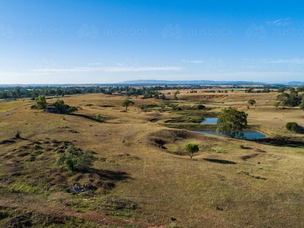 Image of Paddock with trees and dam in summer - Austockphoto