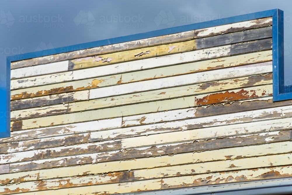 Image of Paint peeling off timber boards on a building facade ...