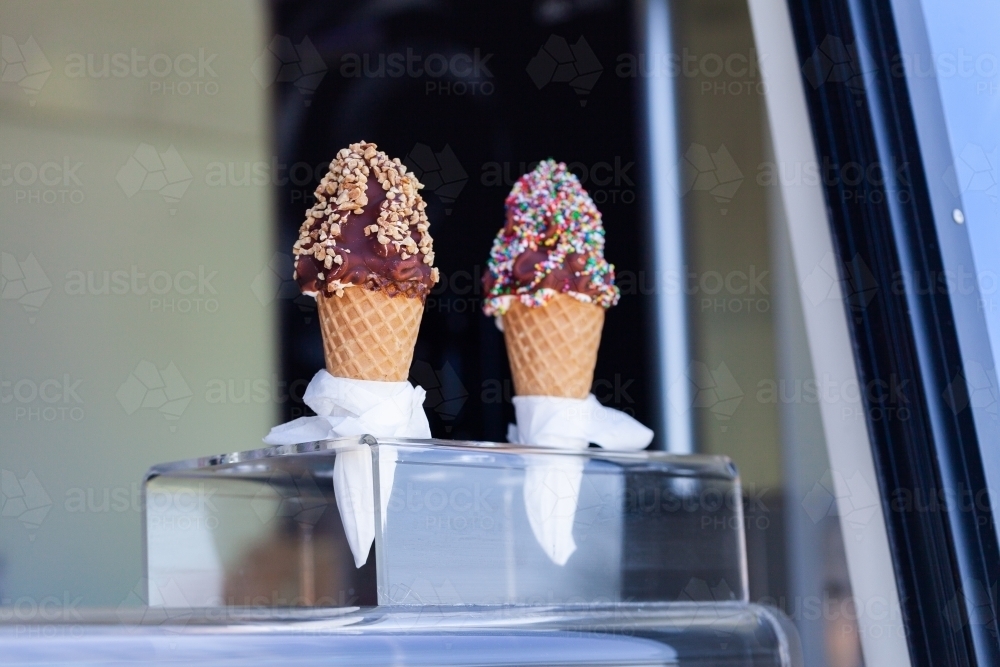 Image of pair of chocolate topped soft serve ice cream waffle cones in ...