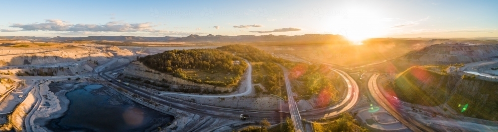 Image of Panoramic aerial view of open cut coal mines surrounding road ...