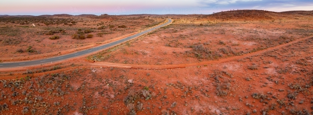 Image of Panoramic aerial view of roads through a barren orange outback ...