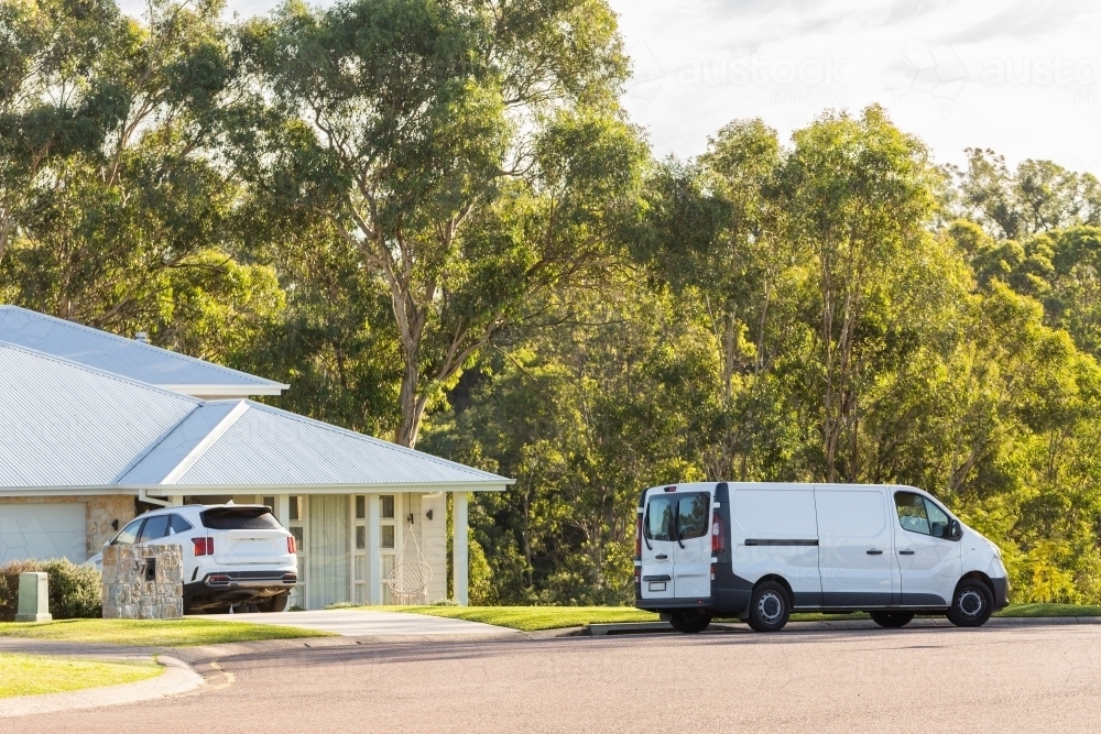 Image of parcel delivery van stopped outside of home to deliver package ...