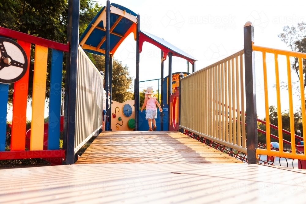 Image of Park playground in afternoon light with child playing on ...