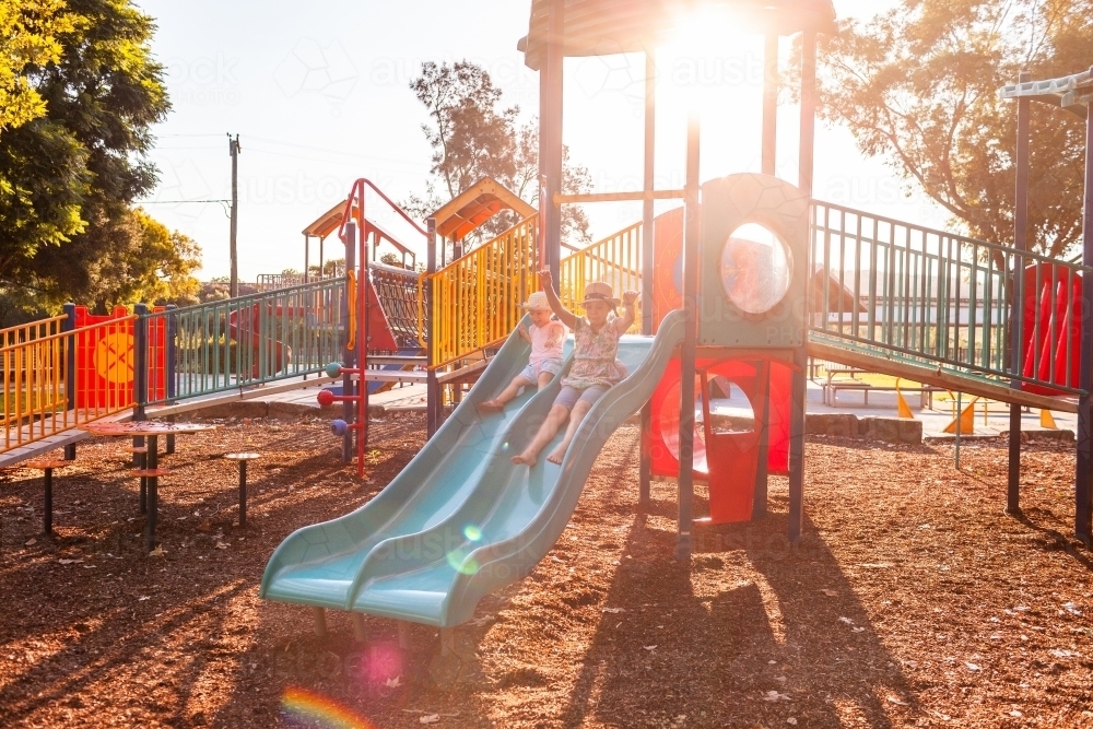 Image of Park playground in afternoon light with children playing on ...