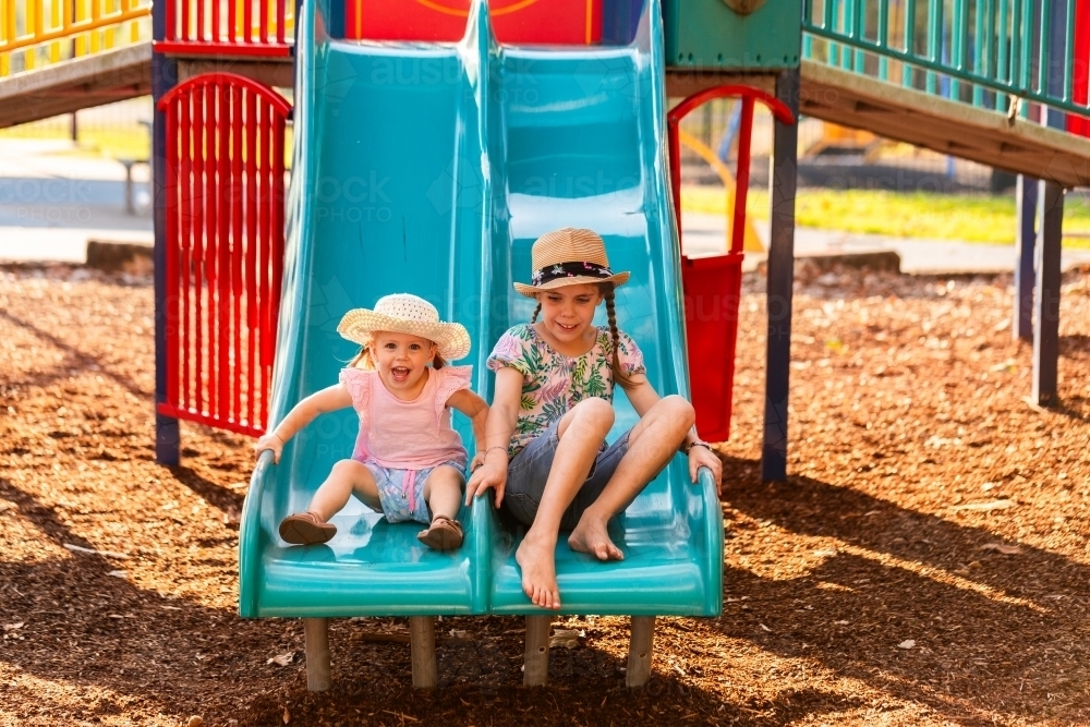 Image of Park playground in afternoon light with kids sliding down ...