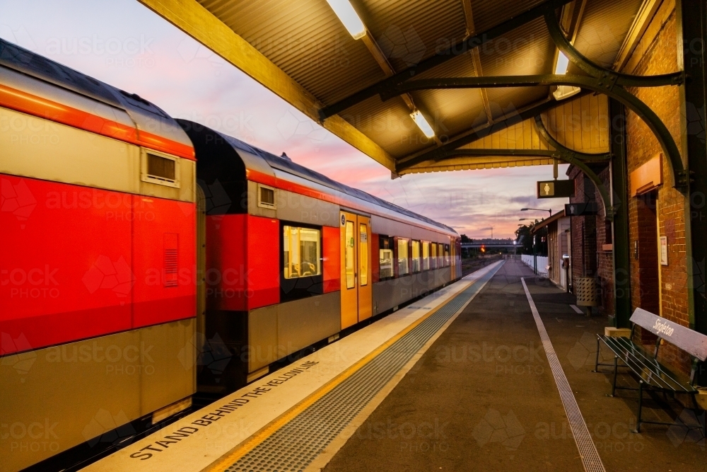 Image of Passenger train pulling away from deserted country railway ...