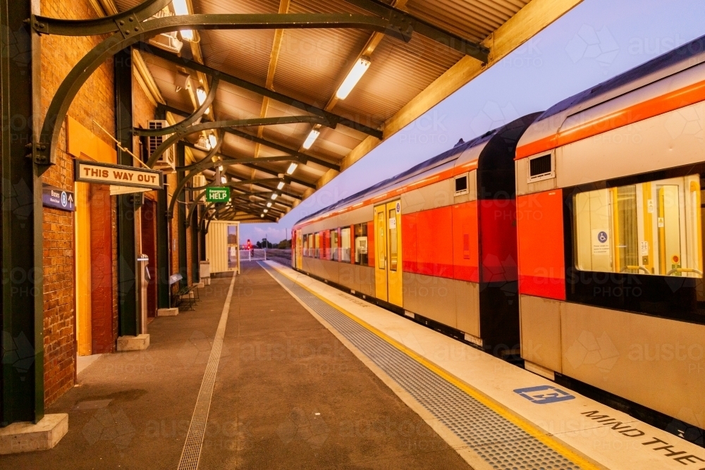 Image of Passenger train pulling away from deserted country railway ...