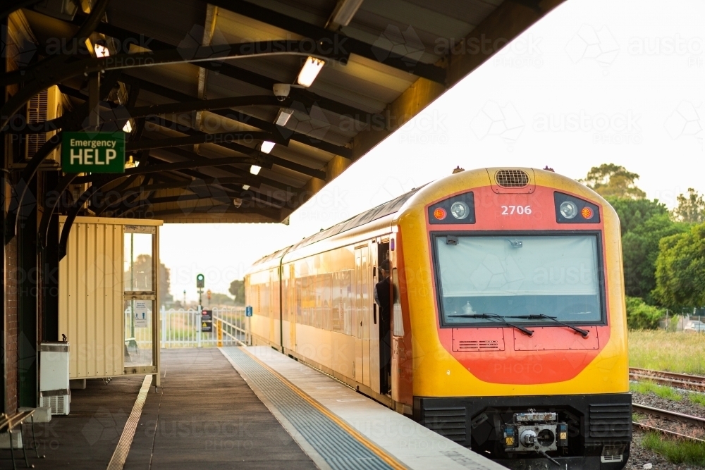 Image of Passenger train pulling away from small country train station ...