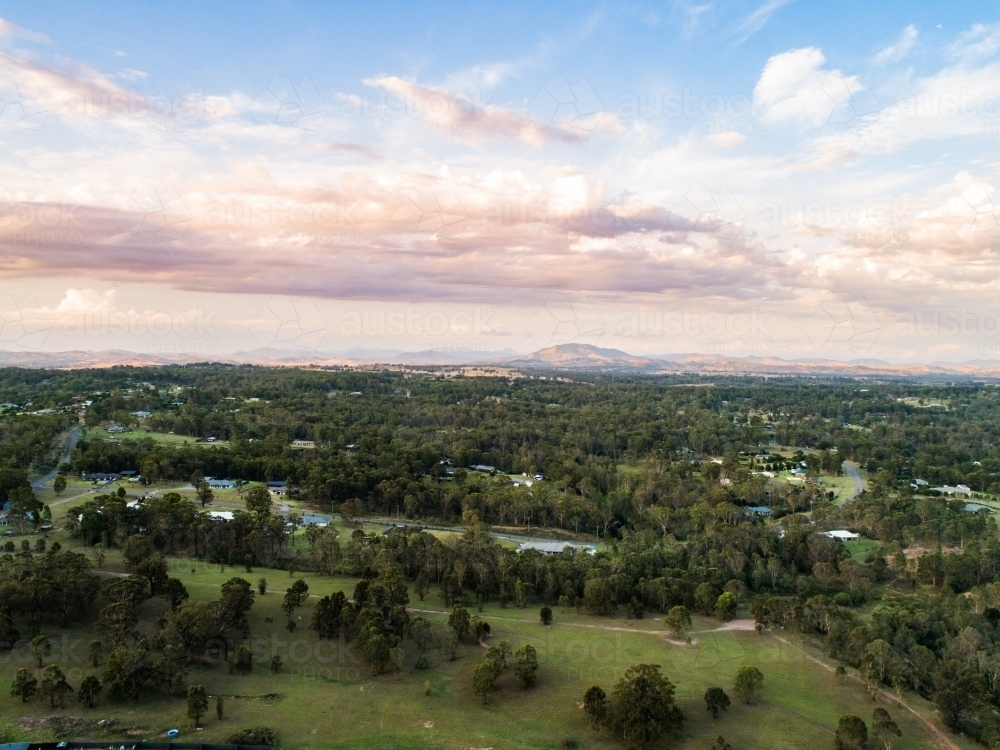 Image of pastel cotton candy clouds and sunlit hills on horizon with ...