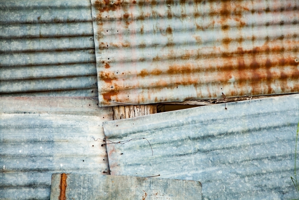 Image of Patched together metal on side of farm shed - Austockphoto