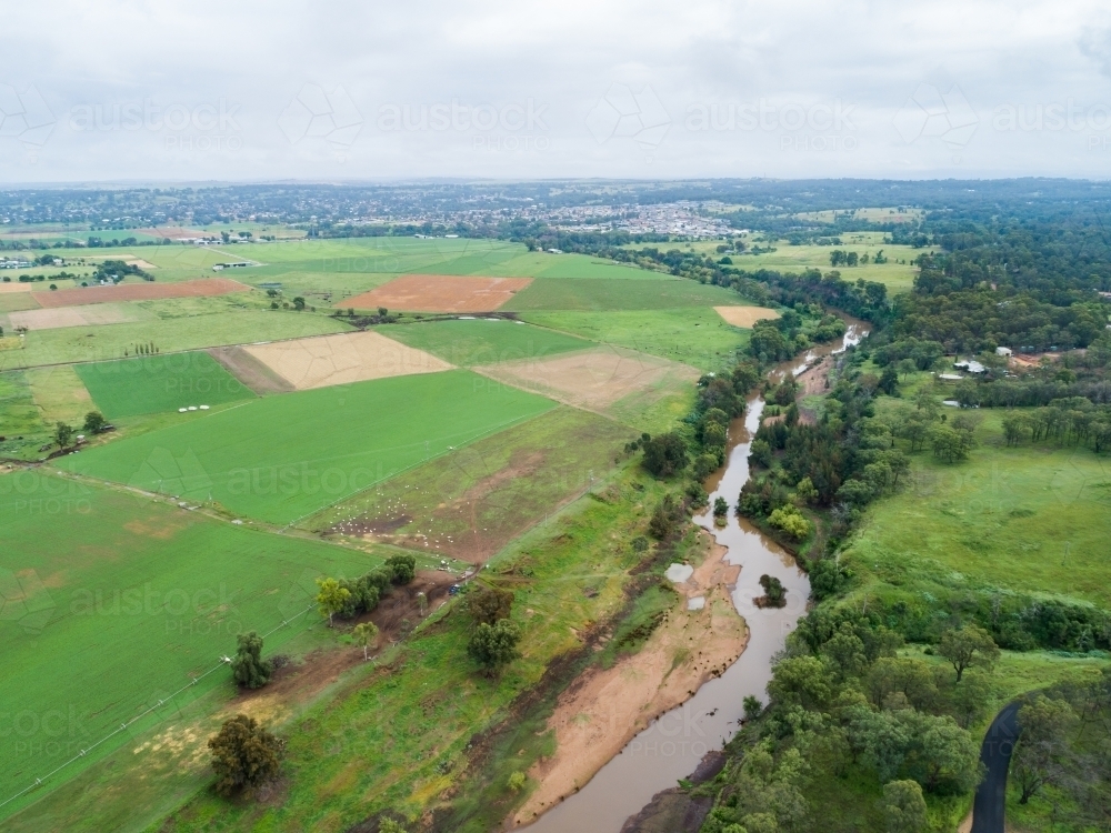 Image of Patchwork of farm paddocks and hunter river with Singleton ...