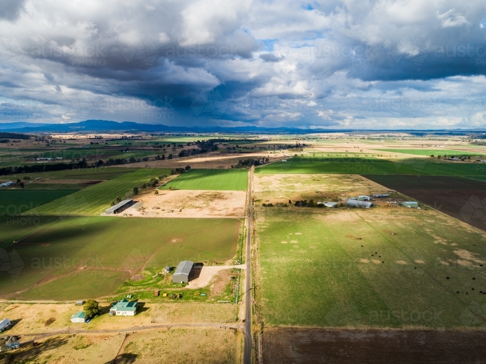 Image of Patchwork of farmland brown and green paddocks with sunlight ...