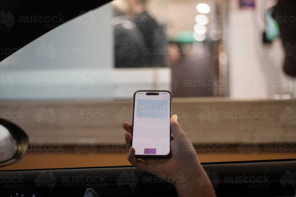 Image of paying with phone at drive thru fast food restaurant ...