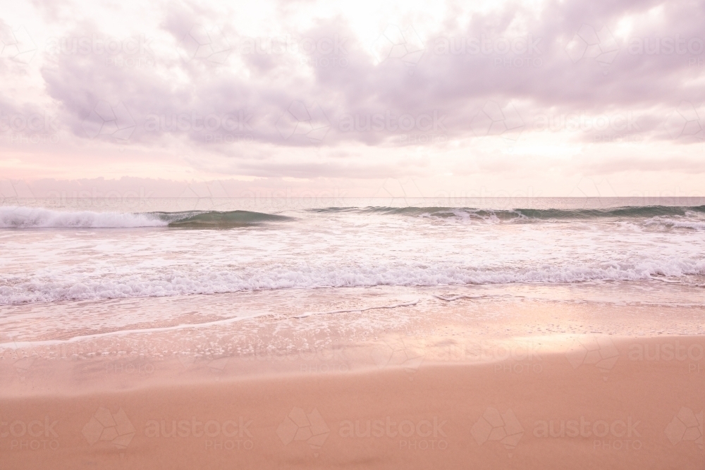 Image of peaceful pastel sunrise over the ocean - Austockphoto