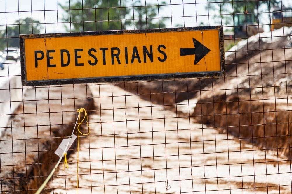 Image of Pedestrians arrow sign at worksite - Austockphoto