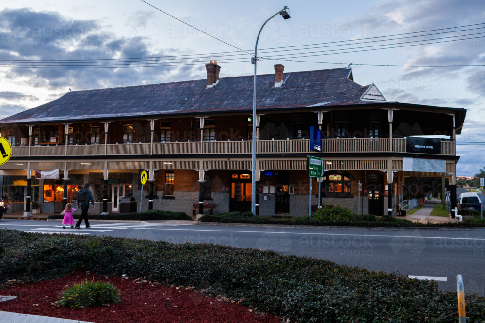 Image of Pedestrians crossing over street in country town on crosswalk ...