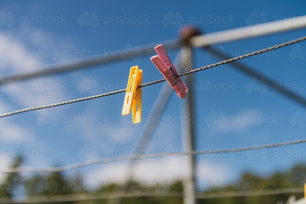 Image of pegs on clothesline - Austockphoto
