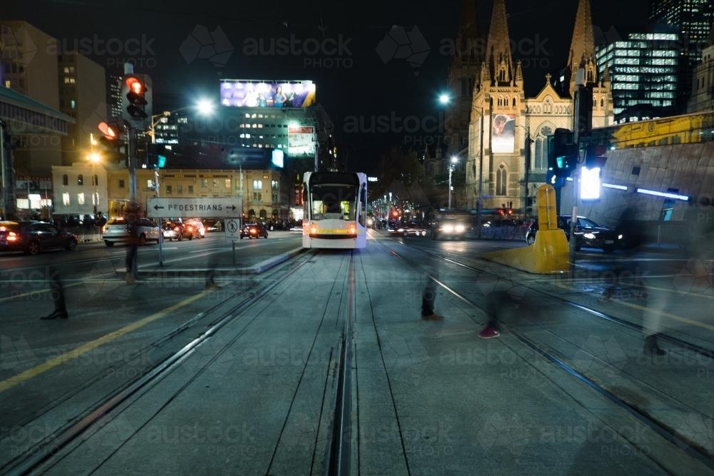 Image of People crossing city street at night - Austockphoto