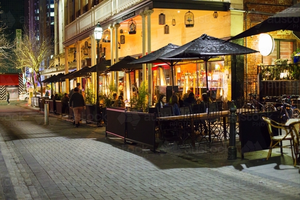 Image of People dining at night - Austockphoto