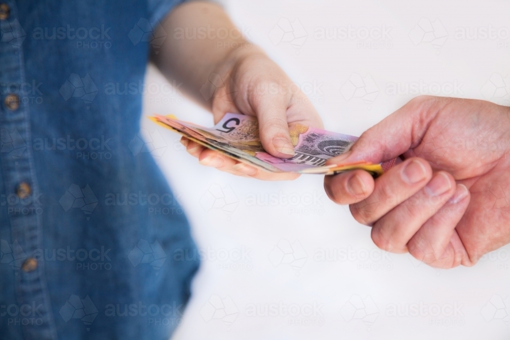 Image of People handing over Australian money notes in payment ...