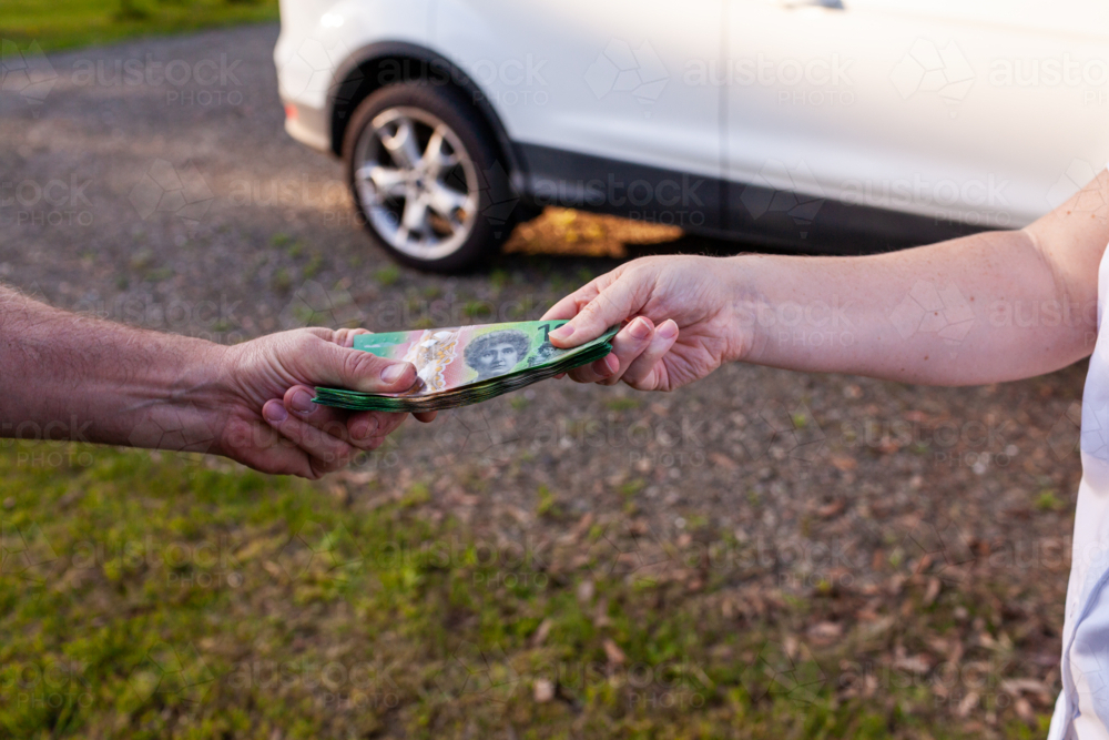 Image of People handing over cash in one hundred dollar notes to pay ...