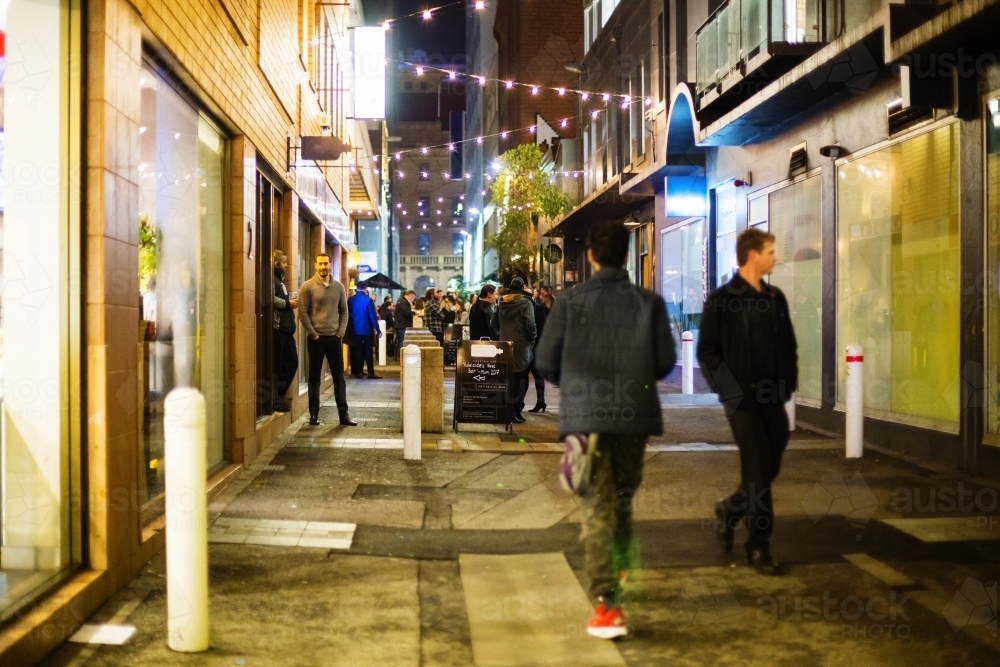 Image of People out in the city at night - Austockphoto