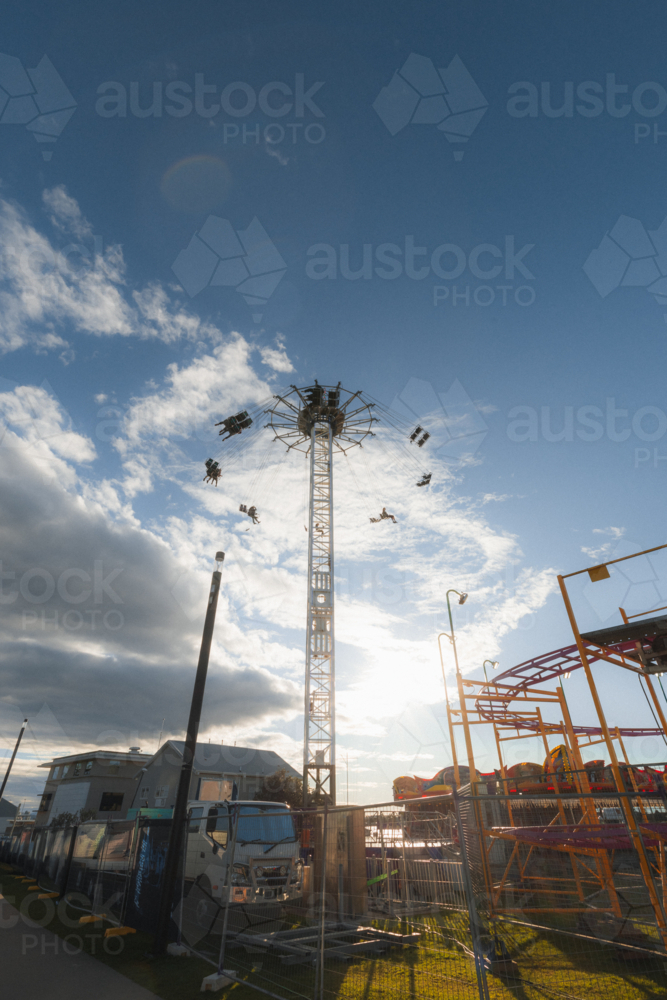 Image of People riding swing chair ride at carnival - Austockphoto