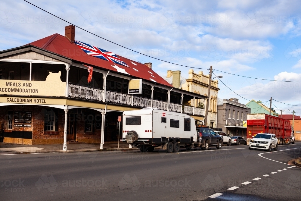 Image of People travelling down highway through country town with ...