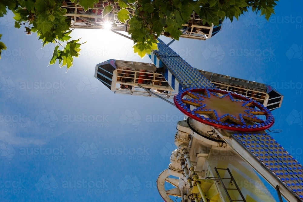 Image of People upside down on a ride at a local show - Austockphoto