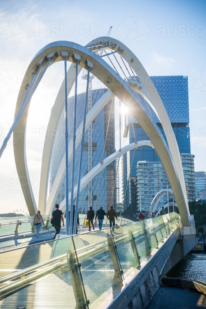 Image of People walking under the arches of modern inner city foot ...