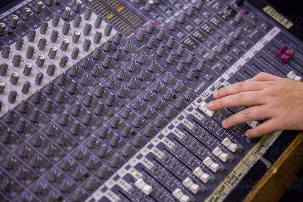 Image of Person adjusting knobs on a sound system - Austockphoto