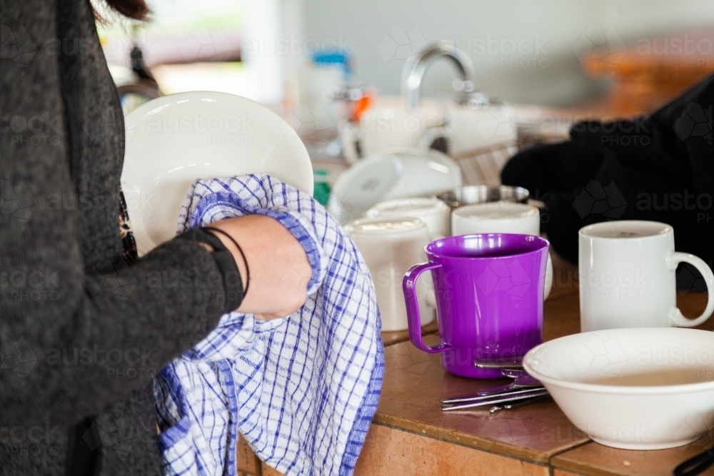 Image of Person drying up dishes beside sink at park campground ...