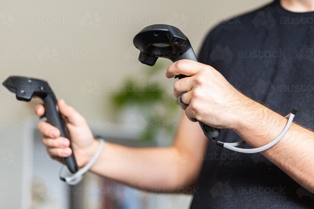 Image of Person with virtual reality hand piece playing fun game inside ...