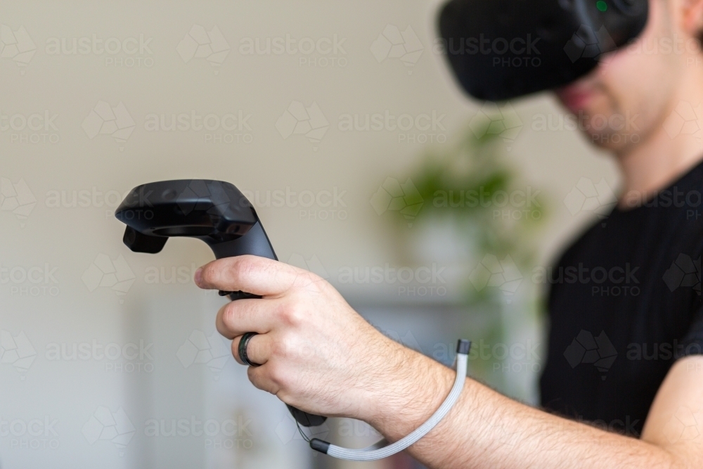 Image of Person with virtual reality hand piece playing fun game inside ...