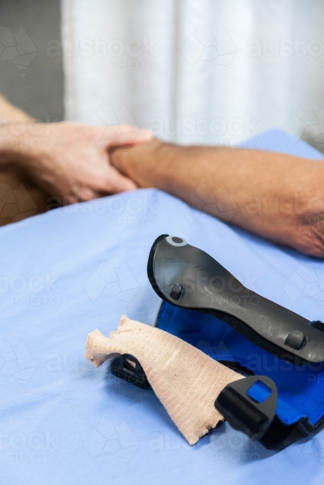 Image of Physio checking wrist injury - Austockphoto