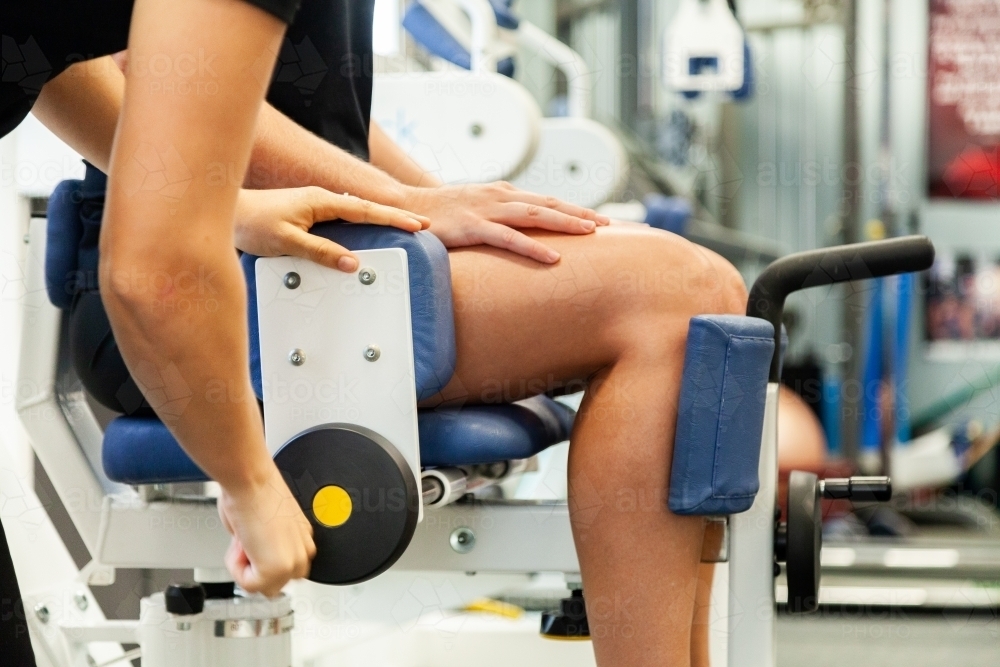 Image of Physio helping client use rehabilitation technology - Austockphoto